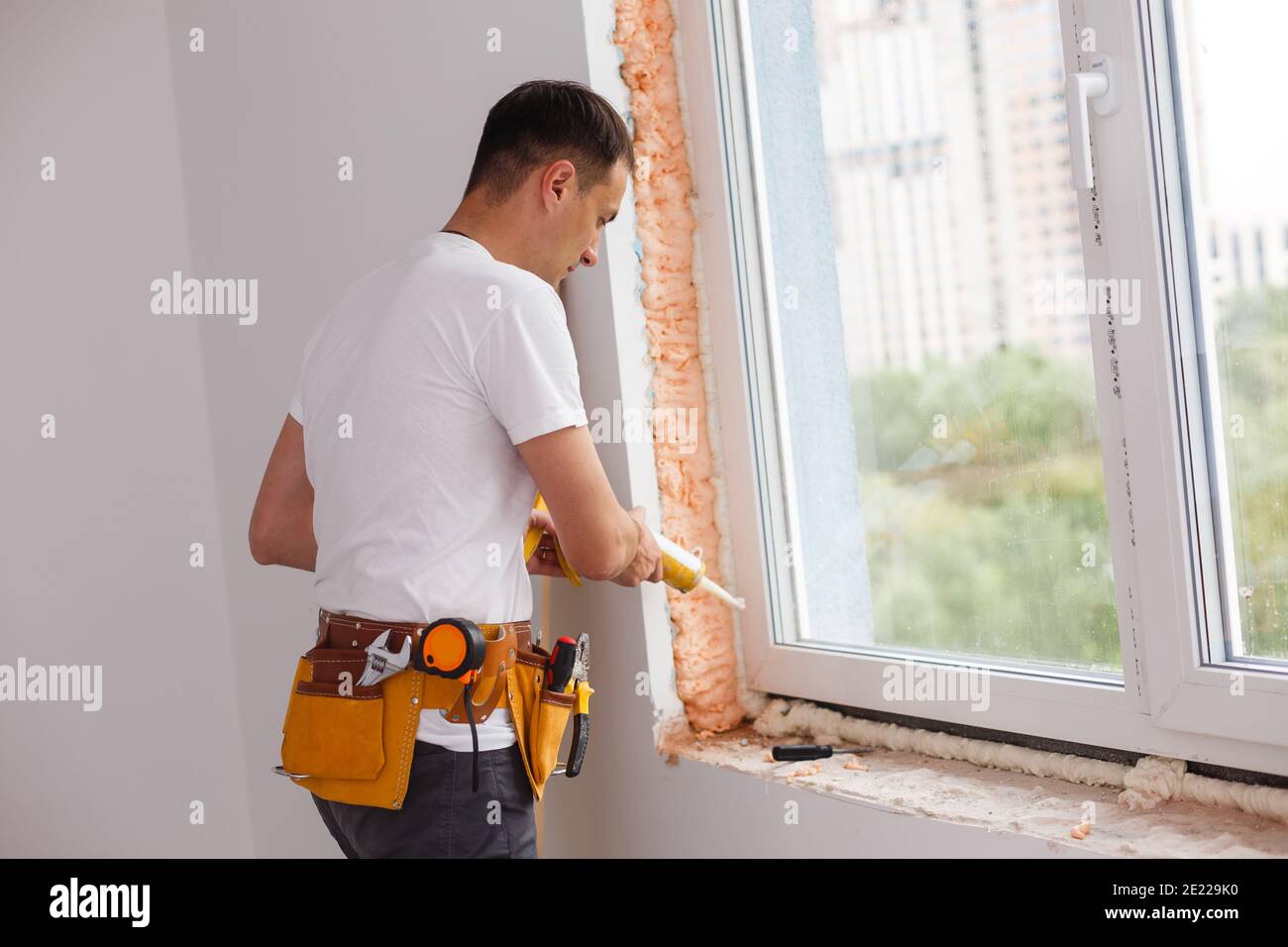 Repairing wall man putting hi-res stock photography and images - Alamy