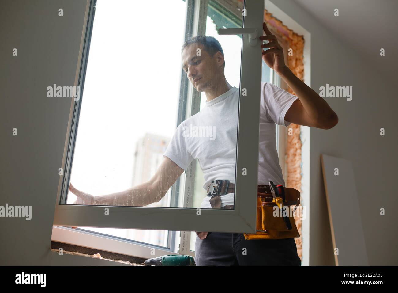 male industrial builder worker at window installation in building ...