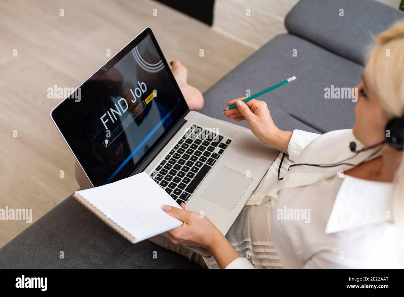 Online job hunting Hands with computer reading employment ads Stock ...