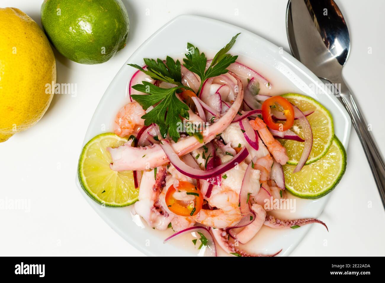 Typical Peruvian food, squid ceviche, shrimp and white fish with purple ...