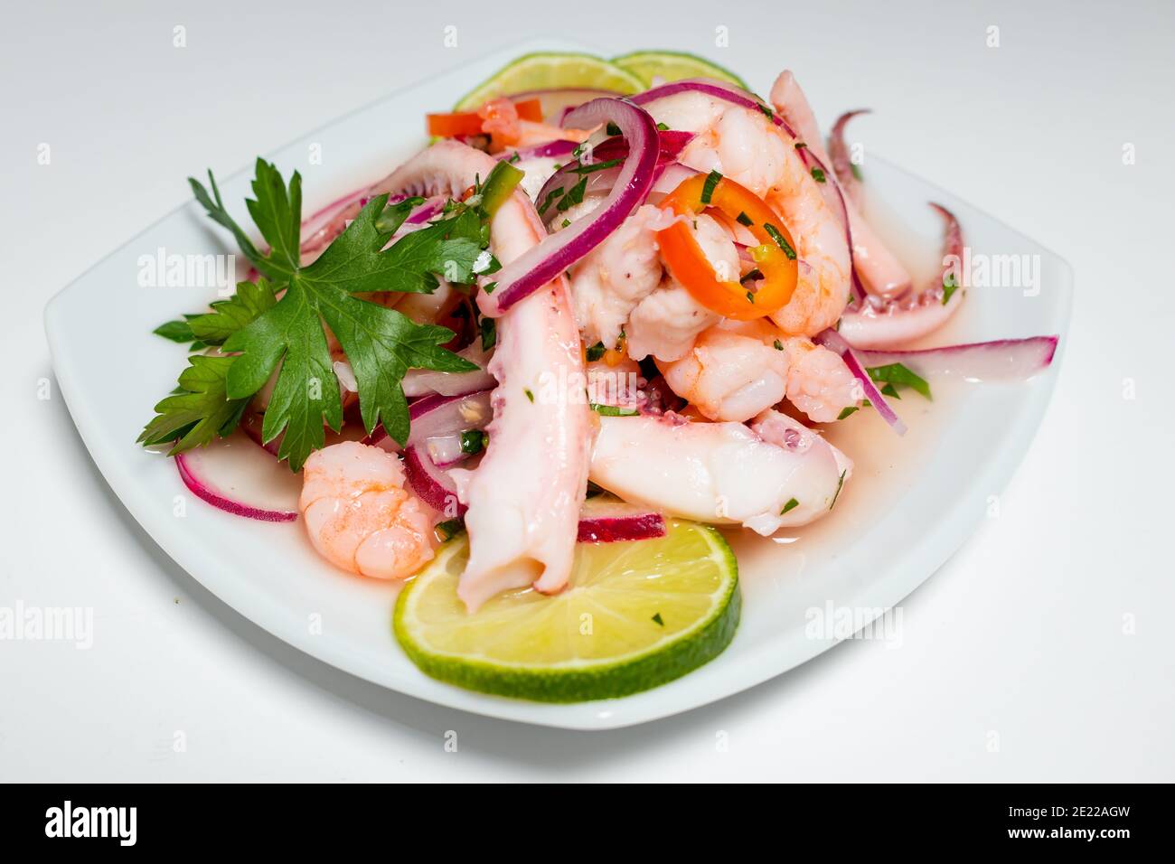 Typical Peruvian food, squid ceviche, shrimp and white fish with purple ...