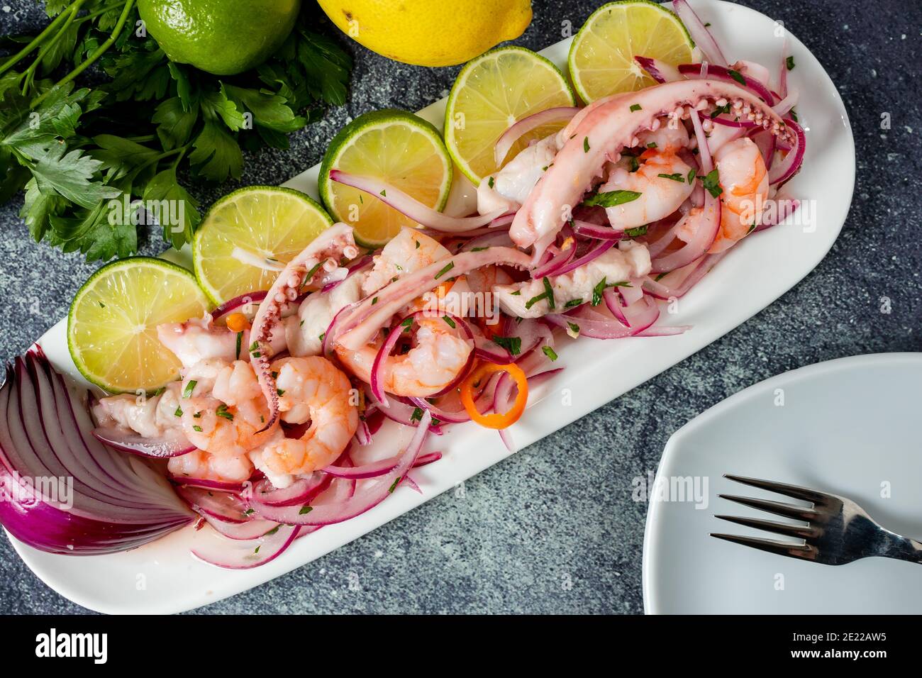 Typical Peruvian food, squid ceviche, shrimp and white fish with purple ...