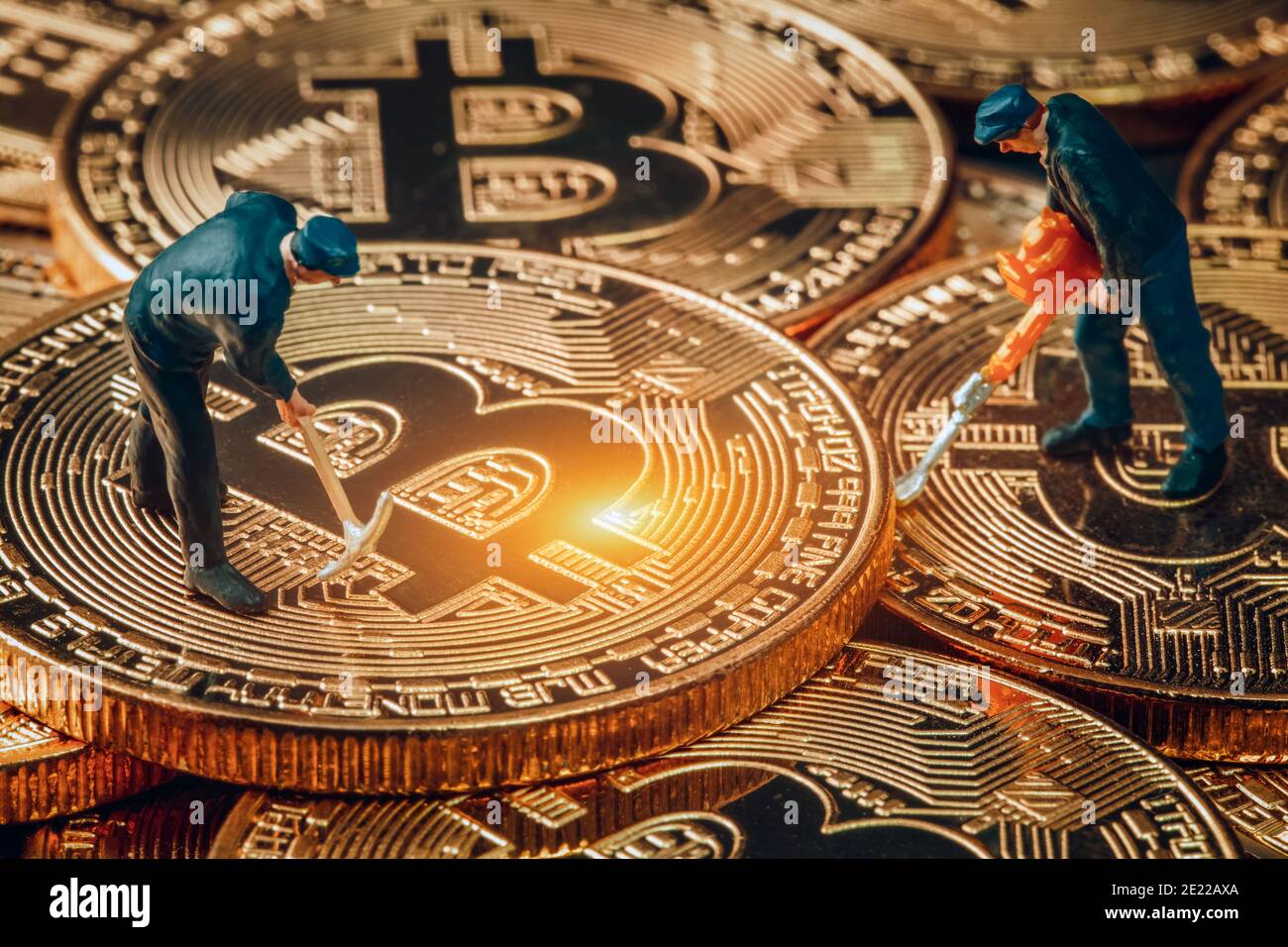 macro miner figurines working on group of bitcoins. virtual ...