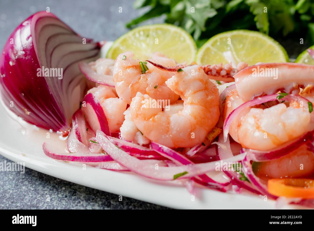 Typical Peruvian food, squid ceviche, shrimp and white fish with purple ...