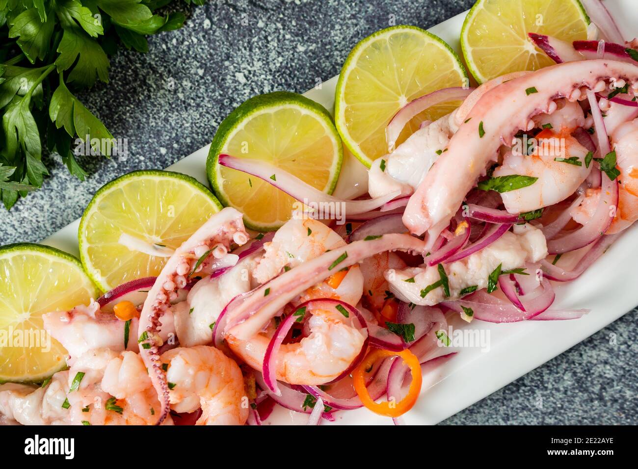 Typical Peruvian food, squid ceviche, shrimp and white fish with purple ...