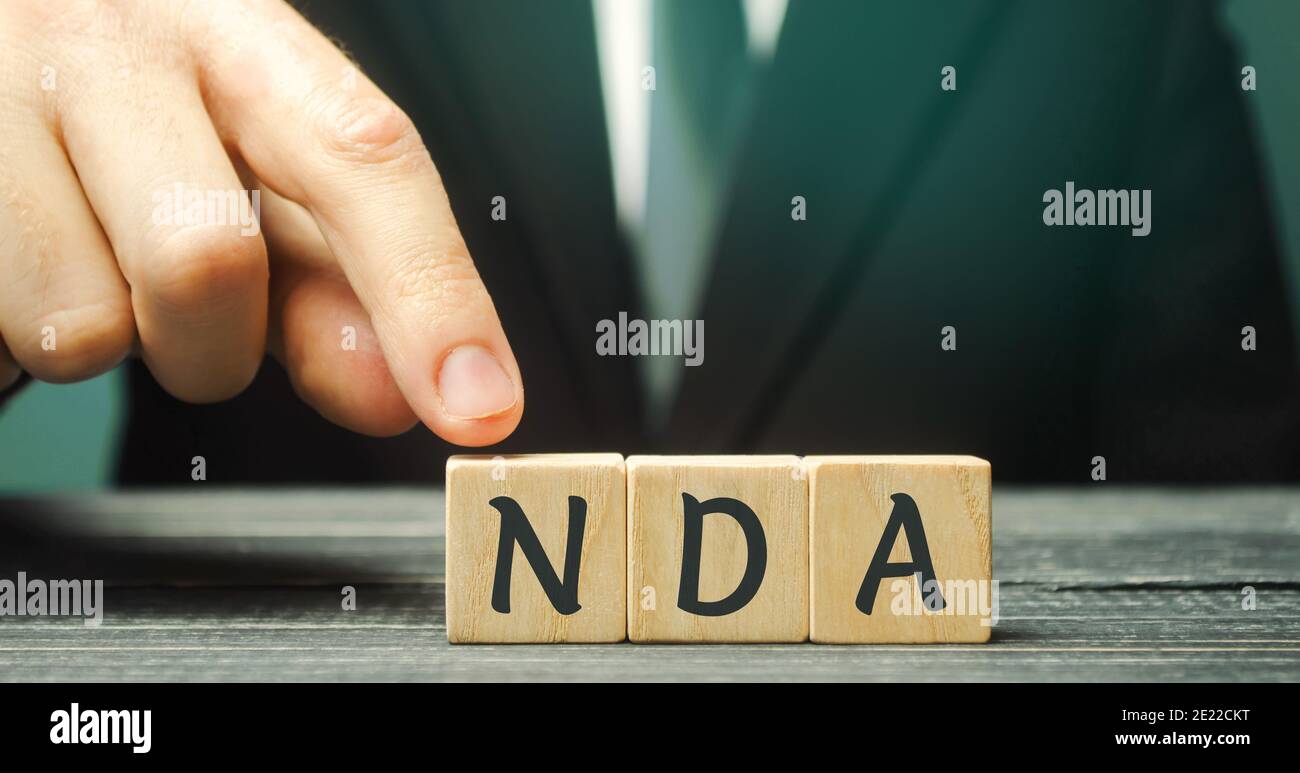 Wooden blocks with the word NDA - Non disclosure agreement. A legal ...