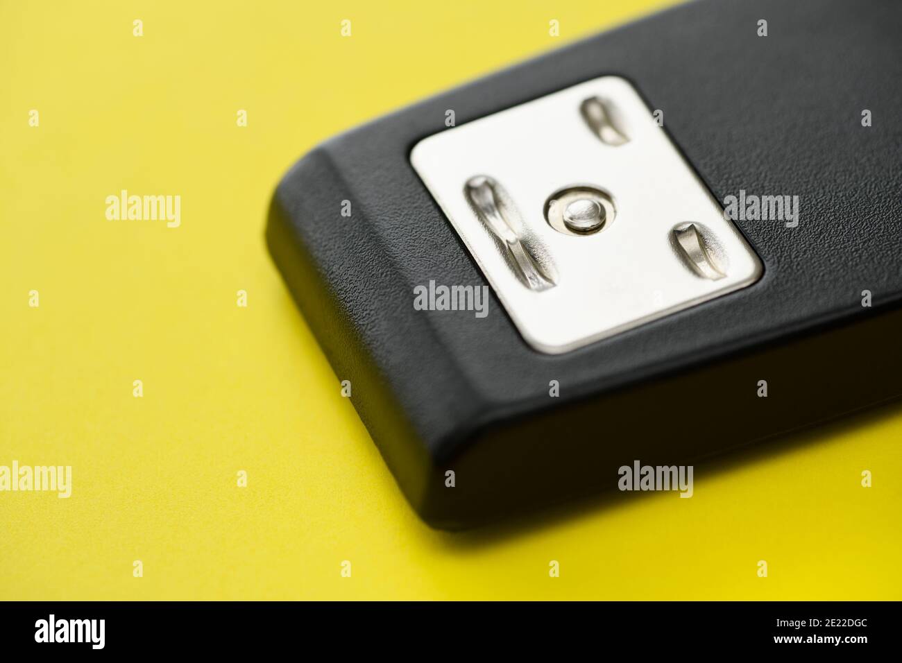 White face on a black stapler on yellow background Stock Photo - Alamy