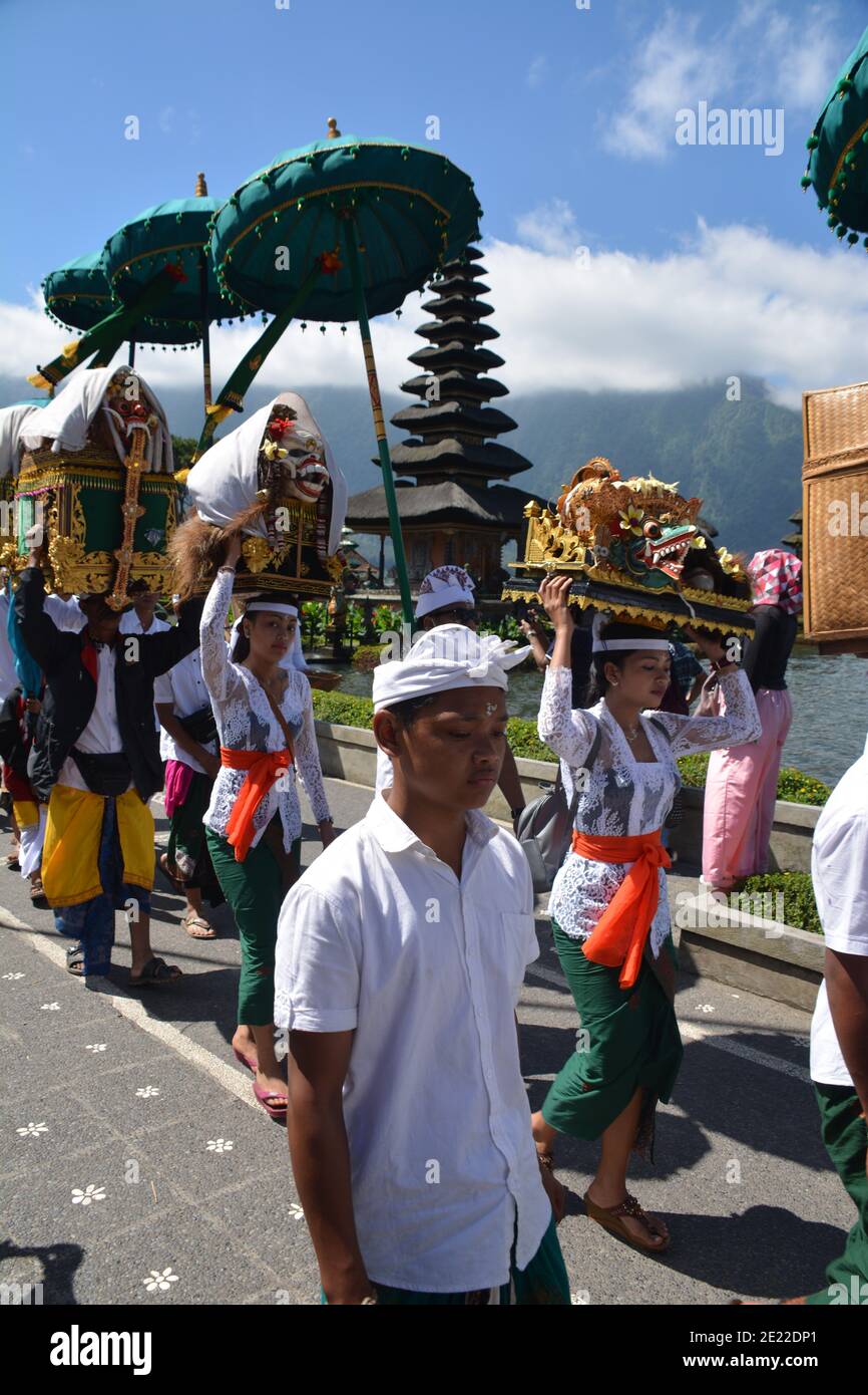 A group of people praying at Pura Ulun Danu Batur temple during the ...