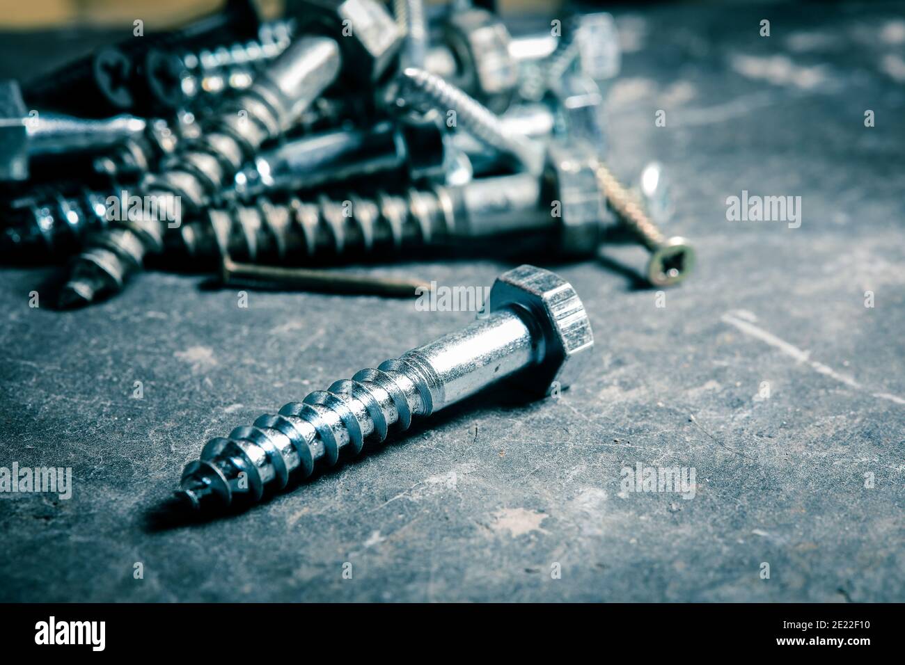 Different Kind of Screws on a table in a workshop Stock Photo - Alamy