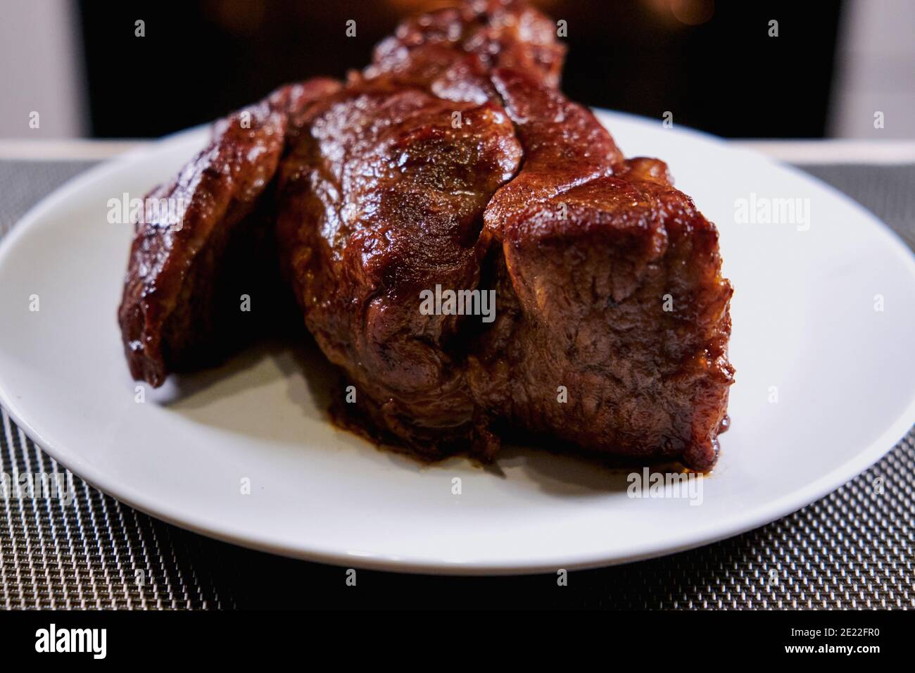 Big piece of meat on plate. Roast beef close-up. Barbecue meat in ...