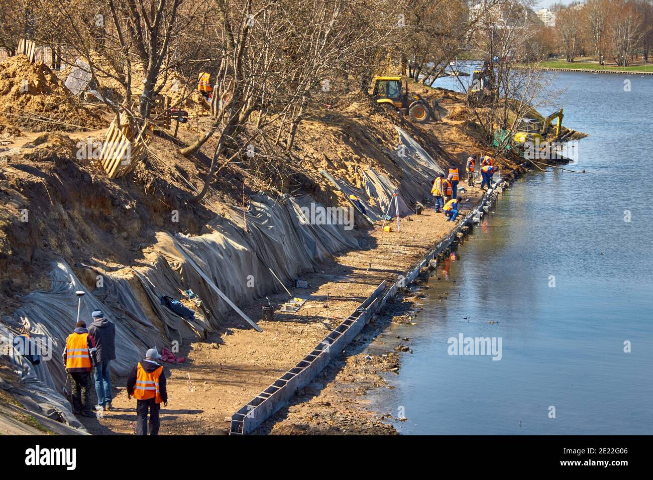 Workers cleaning the river and landscaping the park area Stock Photo ...