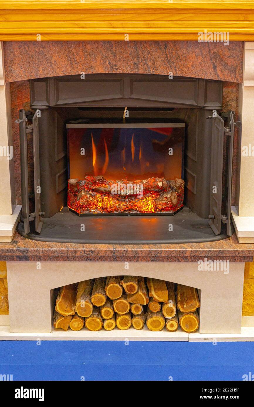 Electronic Fireplace With Ceramic Wood Logs in Home Stock Photo - Alamy