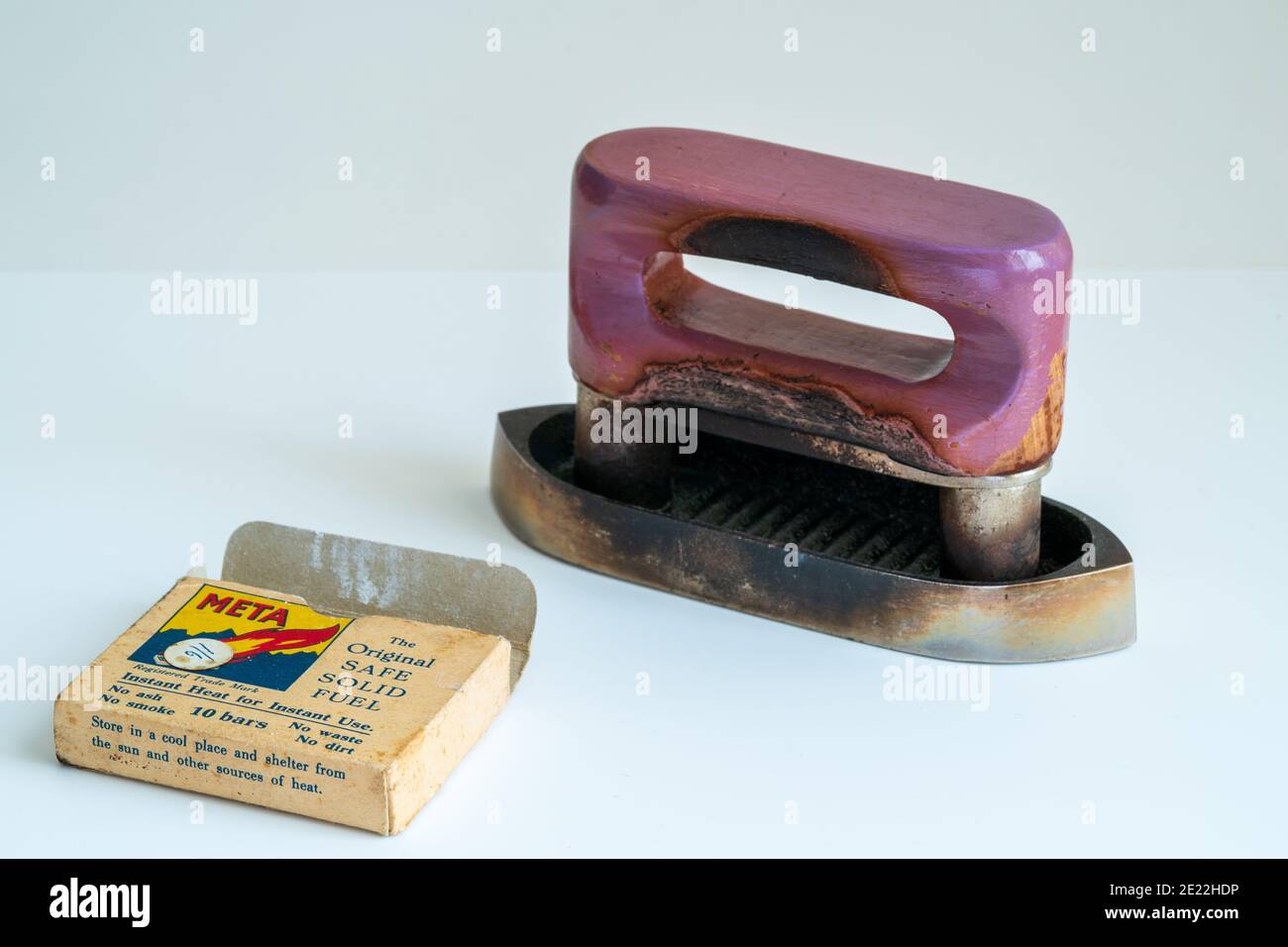 Circa 1930's miniature travel iron with purple handle and a packet of ...