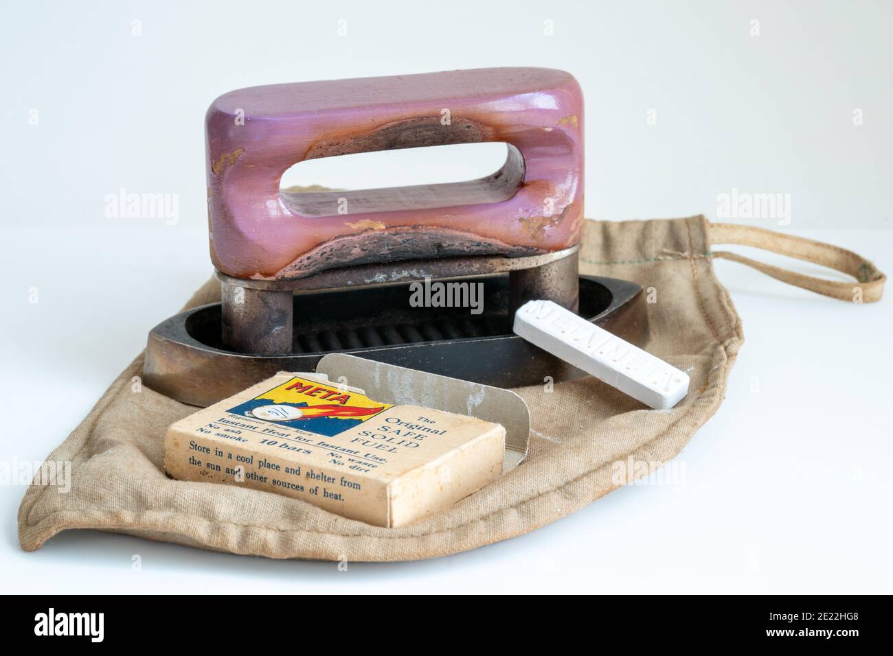 Circa 1930's miniature travel iron with purple handle and a packet of ...