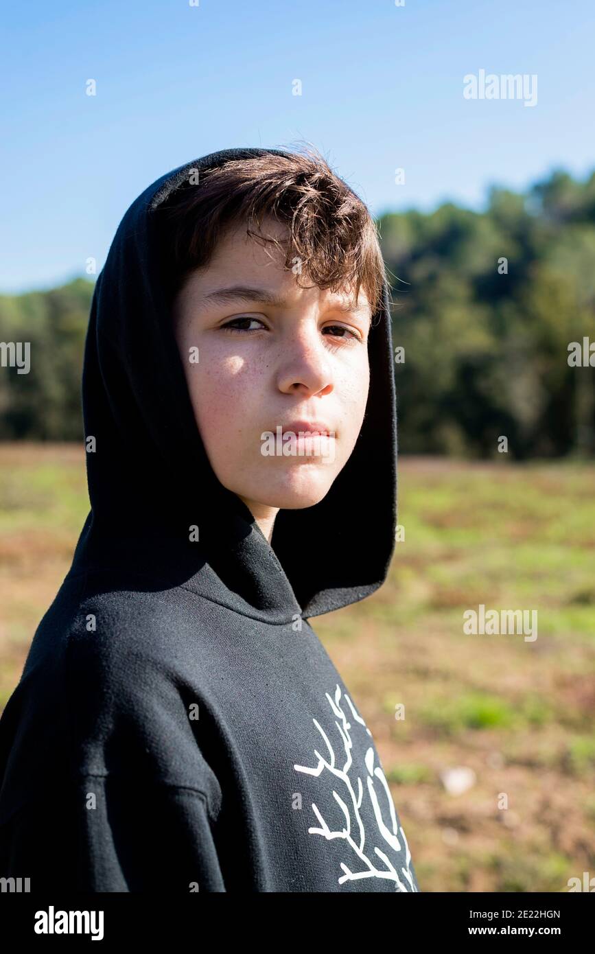 Outdoor handsome boy portrait in hood over park nature background Stock ...