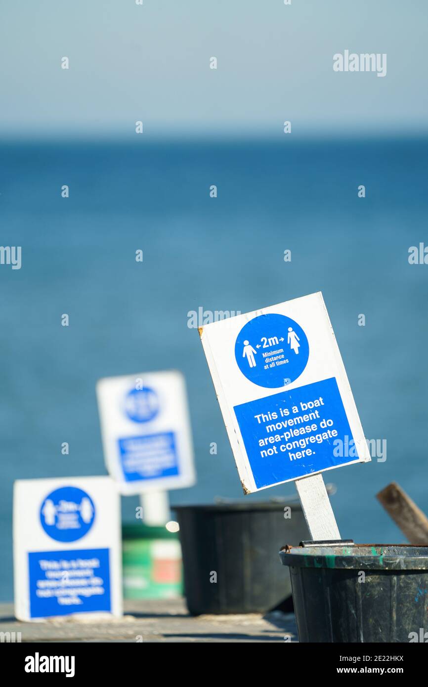 COVID social distance signs on sea front at Whitsable, Kent,. Signs ...