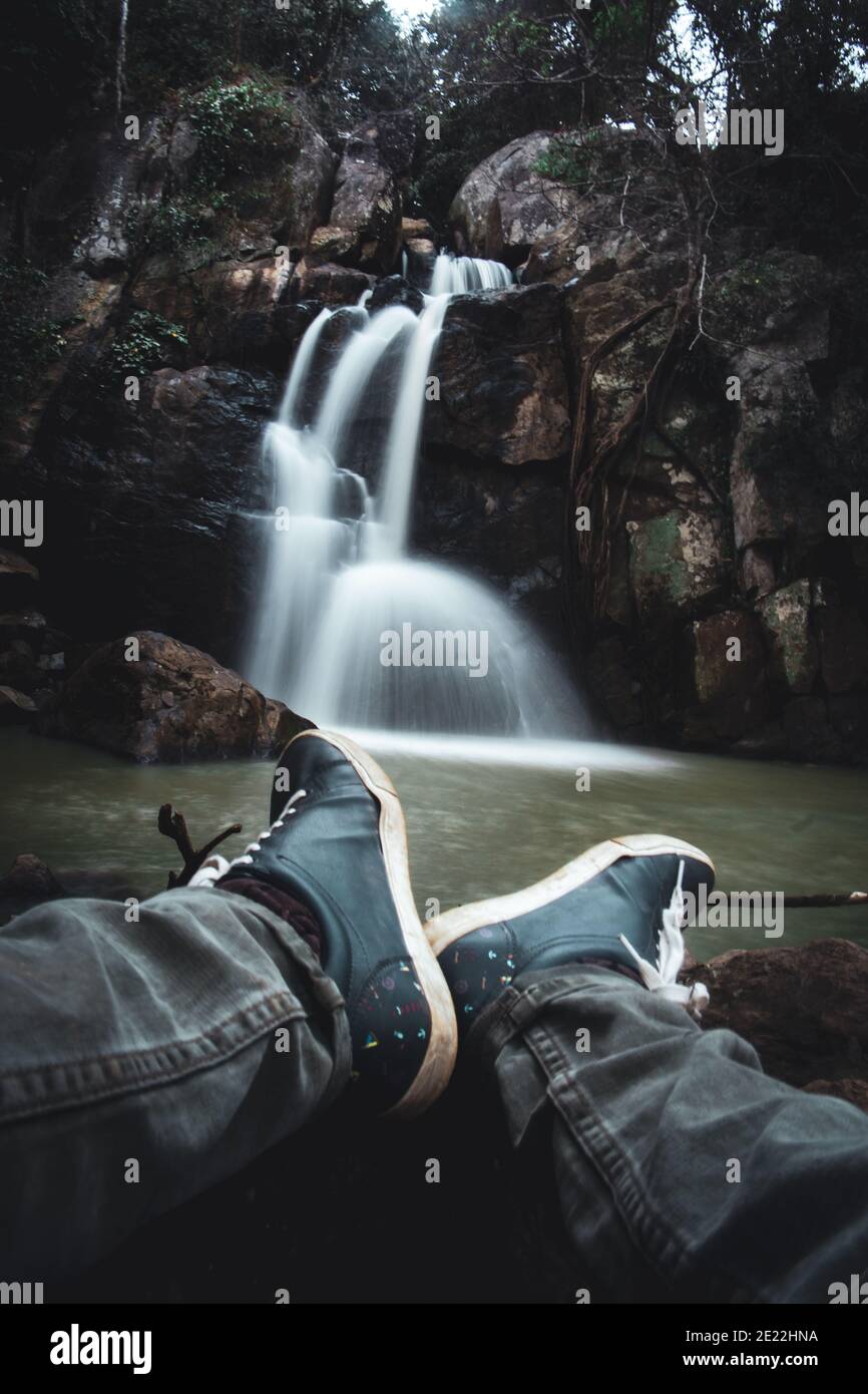 Man sitting in-front of a waterfall Stock Photo - Alamy