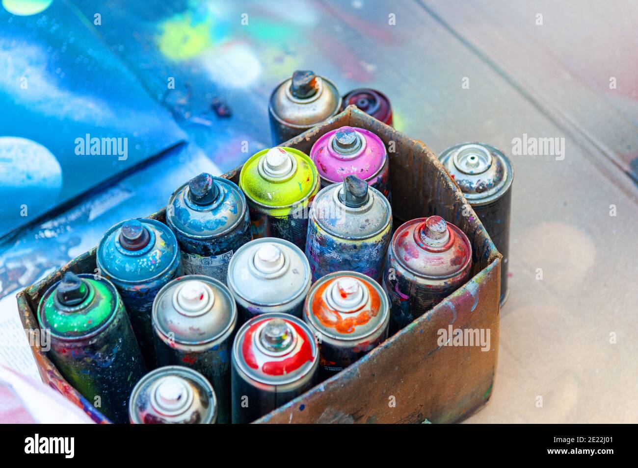 Used aerosol spray paint in cans in carton Stock Photo - Alamy