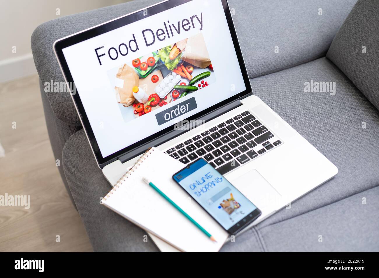 ordering food online concept: woman with a laptop showing fast food ...