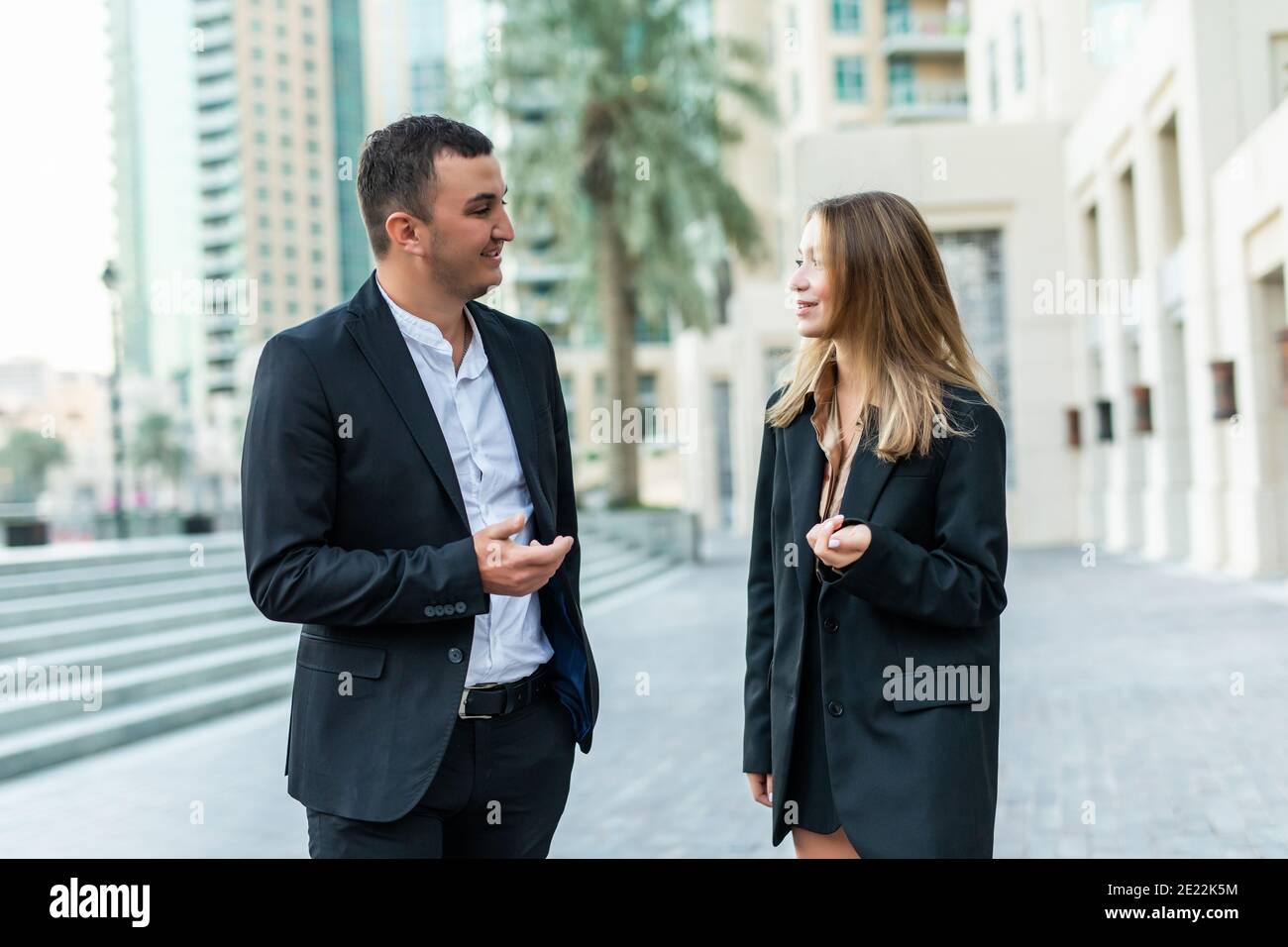 Business people walking and talking in the street Stock Photo - Alamy