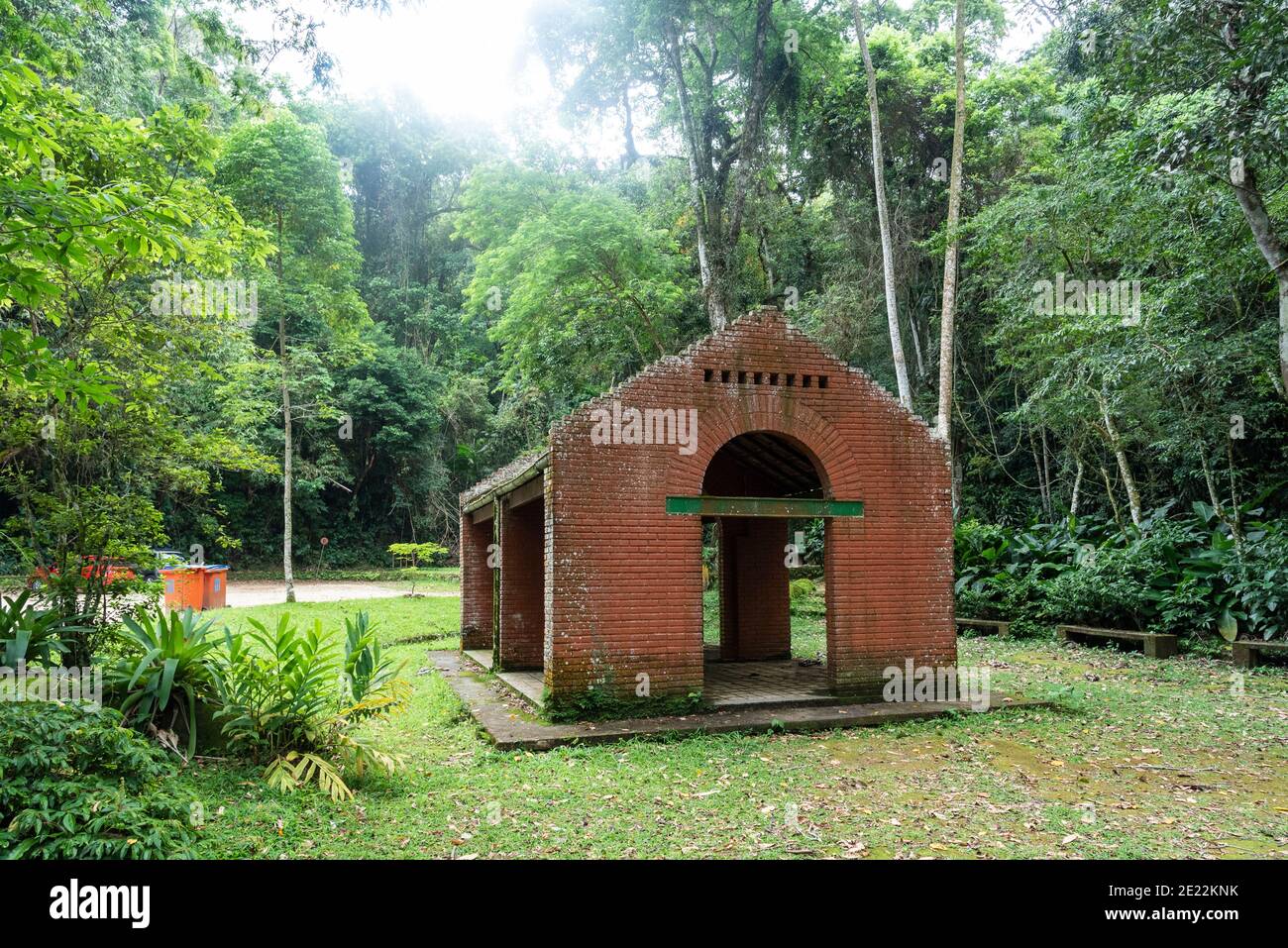 Red brick rustic building on green atlantic rainforest area in Tijuca ...