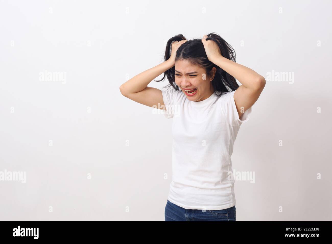 A Frustrated And Angry Asian Woman Is Screaming Out Loud And Pulling
