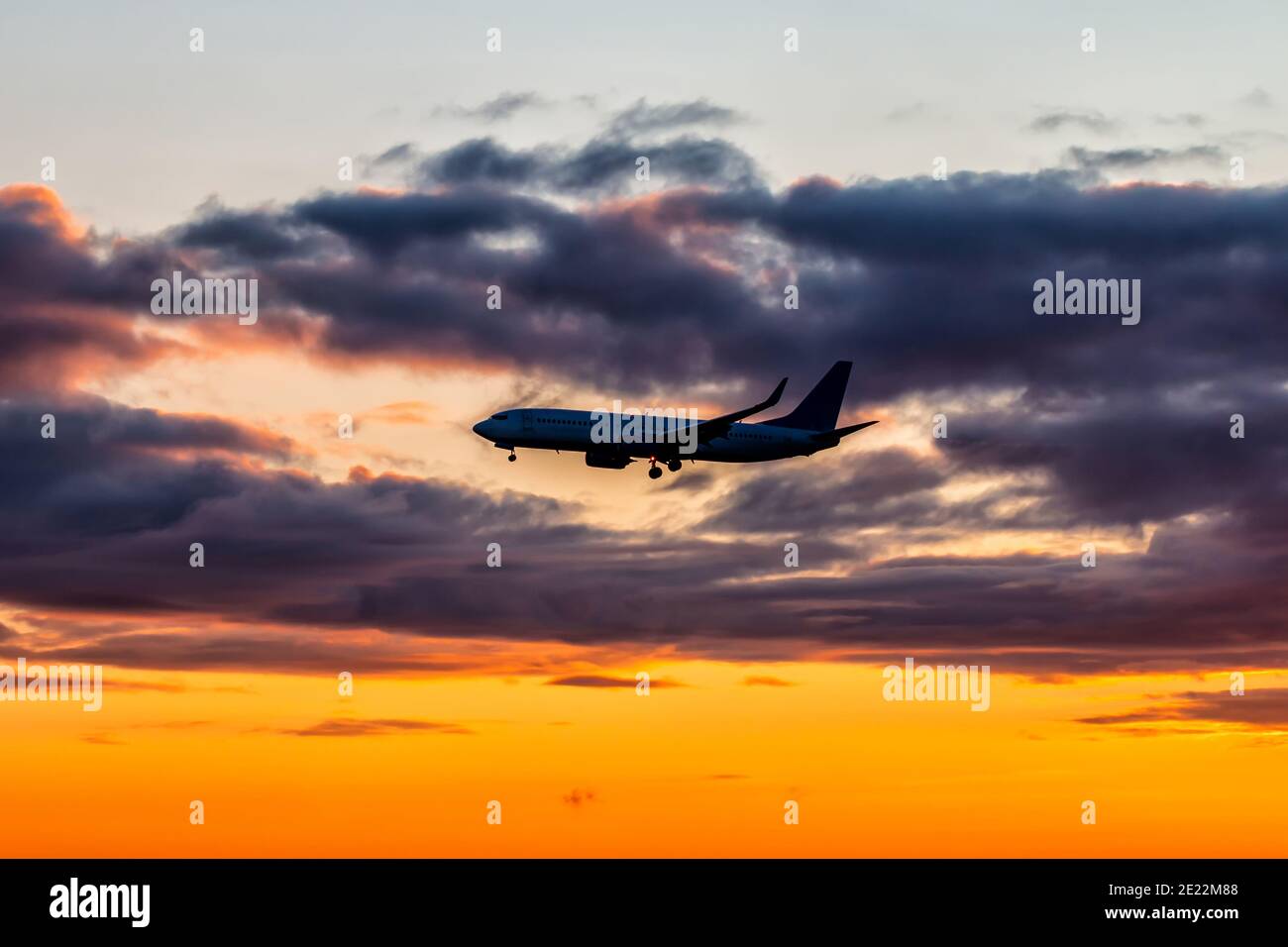 Early morning passenger aircraft flying against the backdrop of a ...
