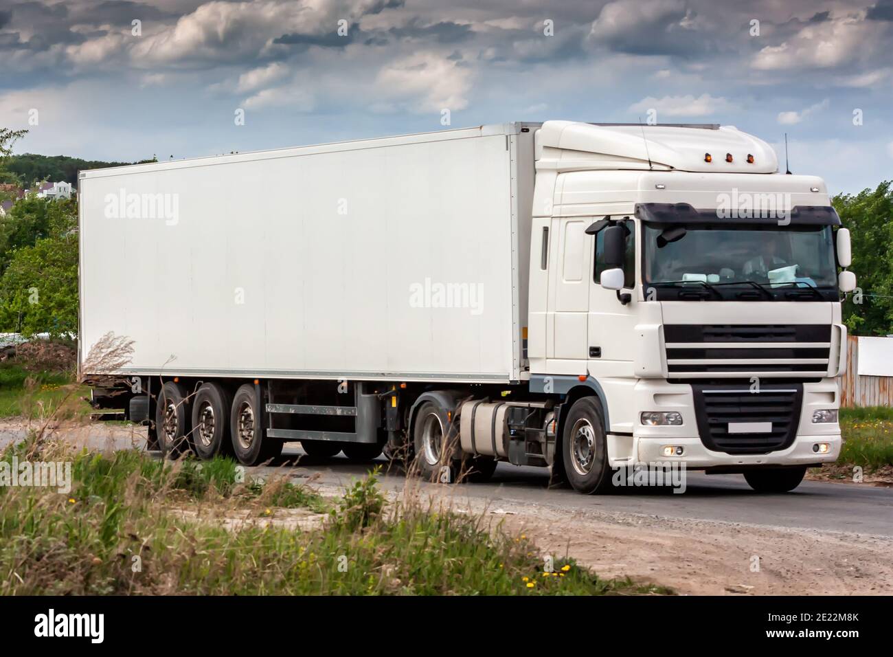 All white long-distance truck with a semitrailer moves in the ...