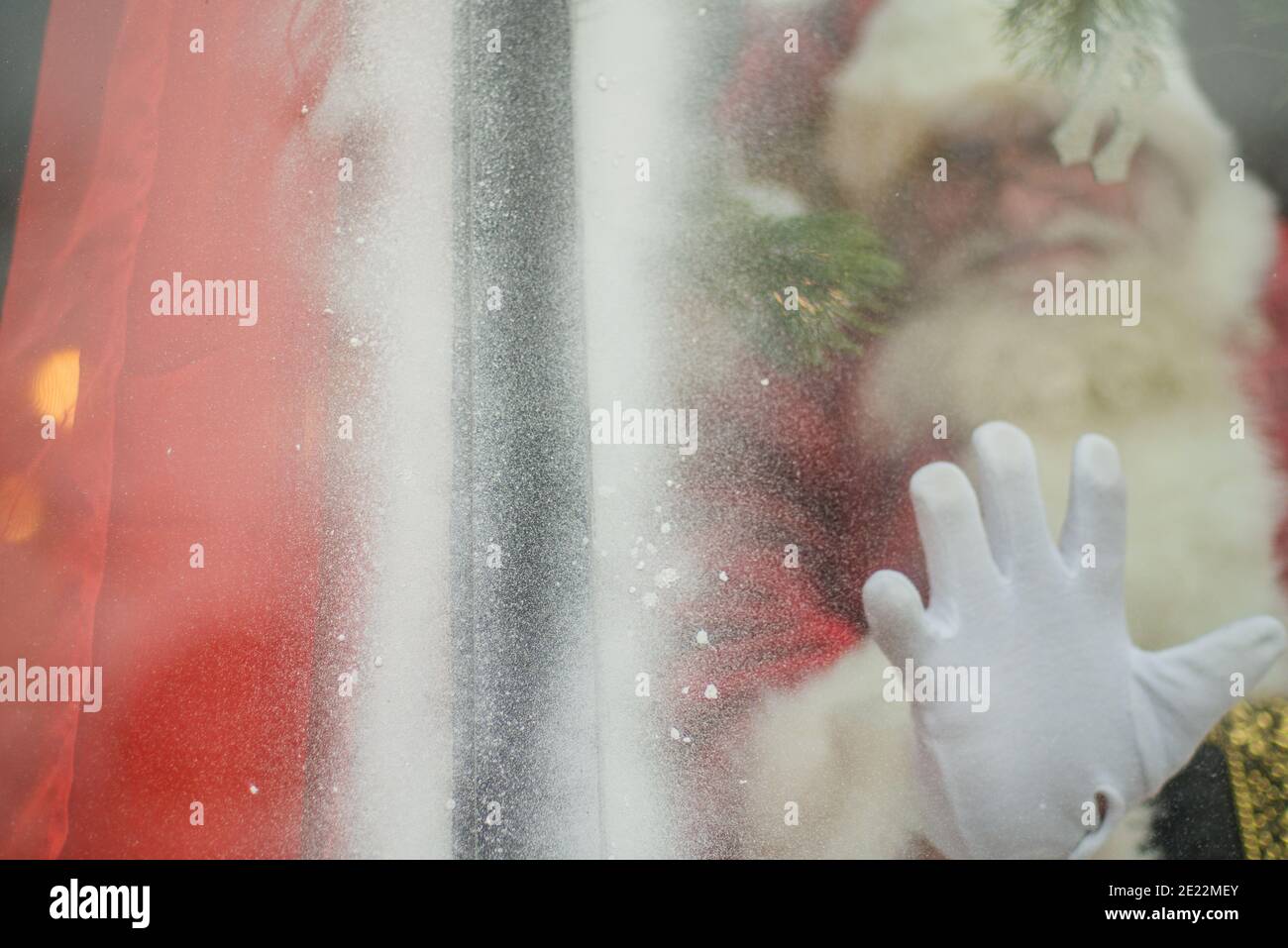 Santa reaches out to connect through window Stock Photo - Alamy
