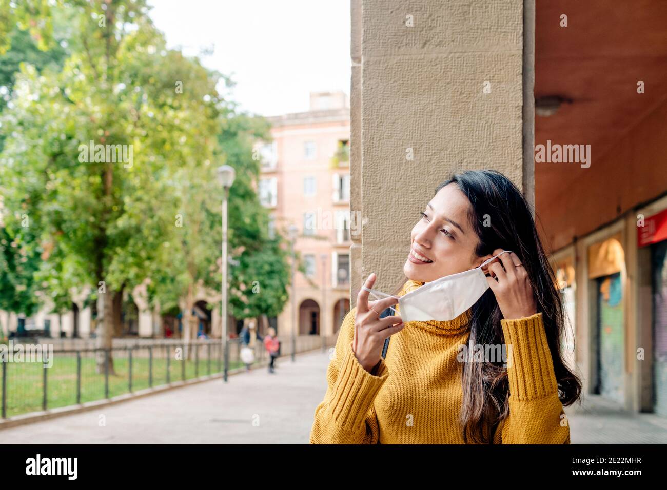 Woman putting on a mask hi-res stock photography and images - Alamy