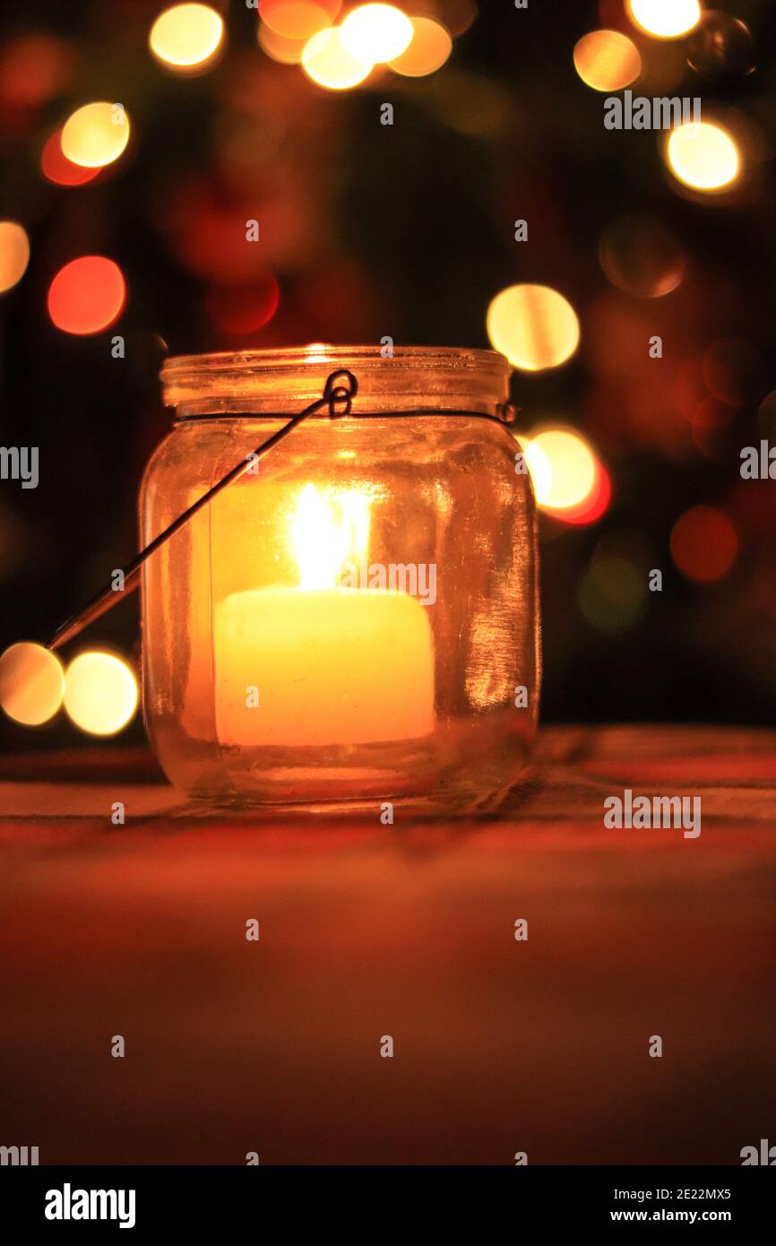 glass jar with lit candle inside with Bokeh lights in background Stock ...