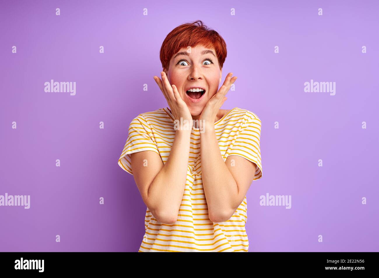 excited woman is surprised by something, stand shouting, expressing ...