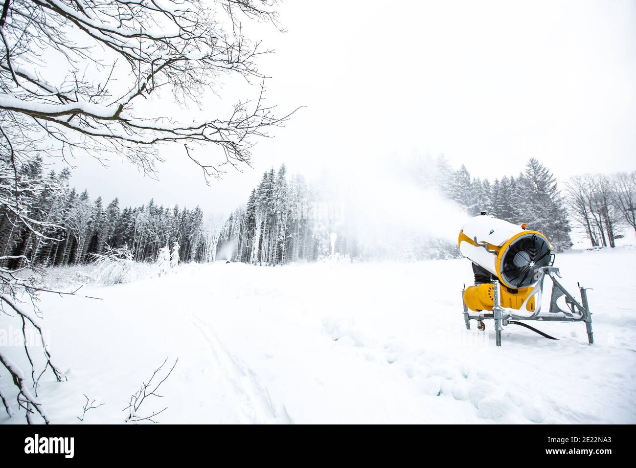 Snow cannon, machine or gun snowing the slopes or mountain for skiers ...