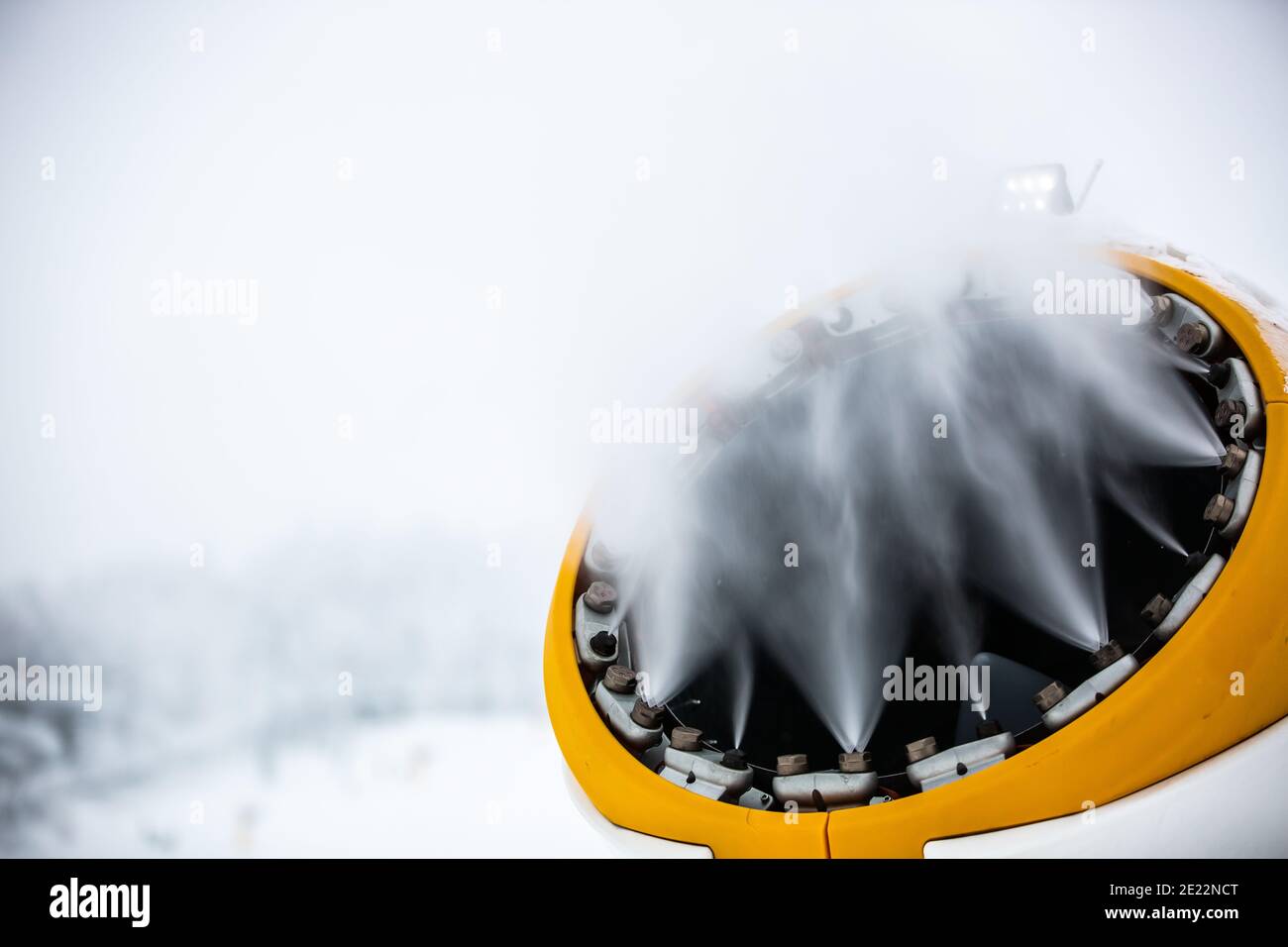 Snow cannon, machine or gun snowing the slopes or mountain for skiers ...