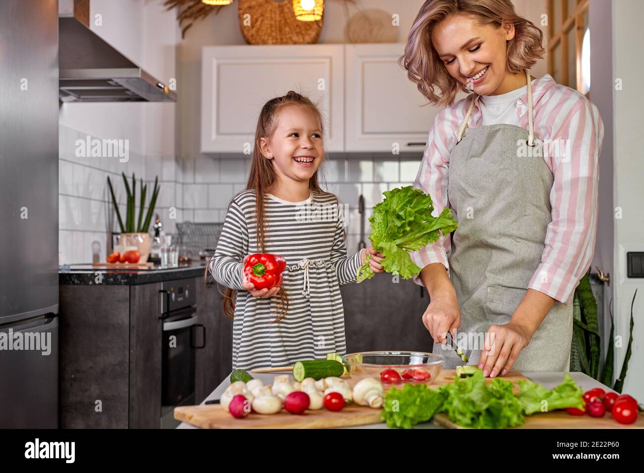 family have fun while cooking in the kitchen, adorable woman with child ...