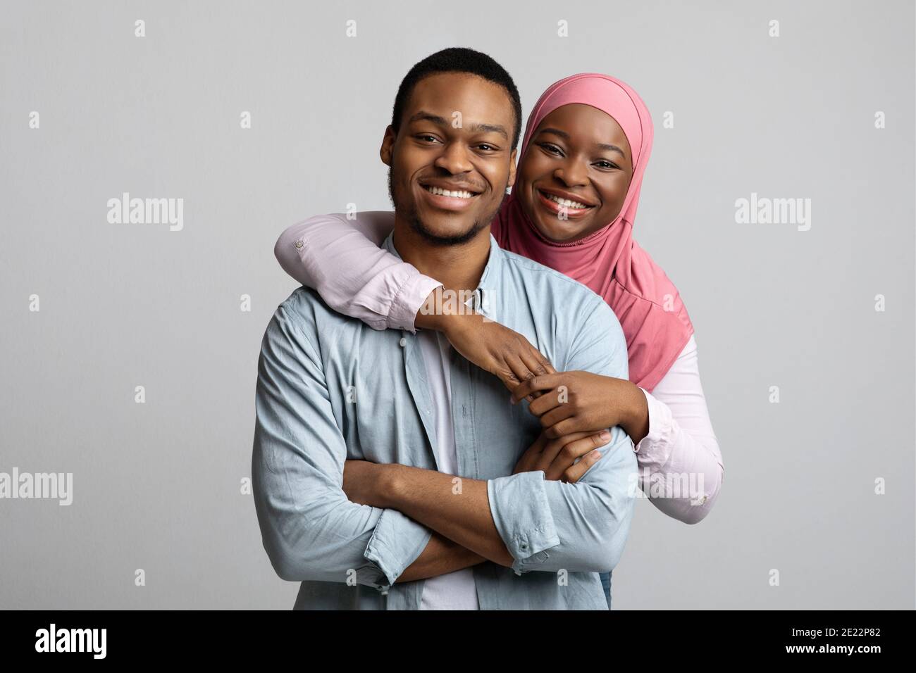 Portrait of loving african american muslim couple posing on grey Stock ...