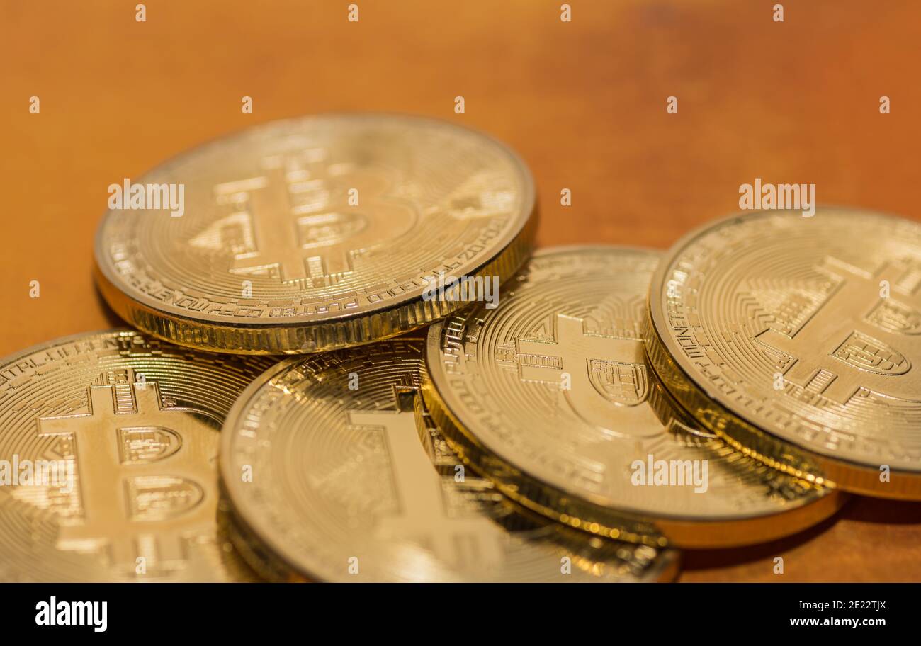 bitcoins lie on top of each other on a golden background detail view ...