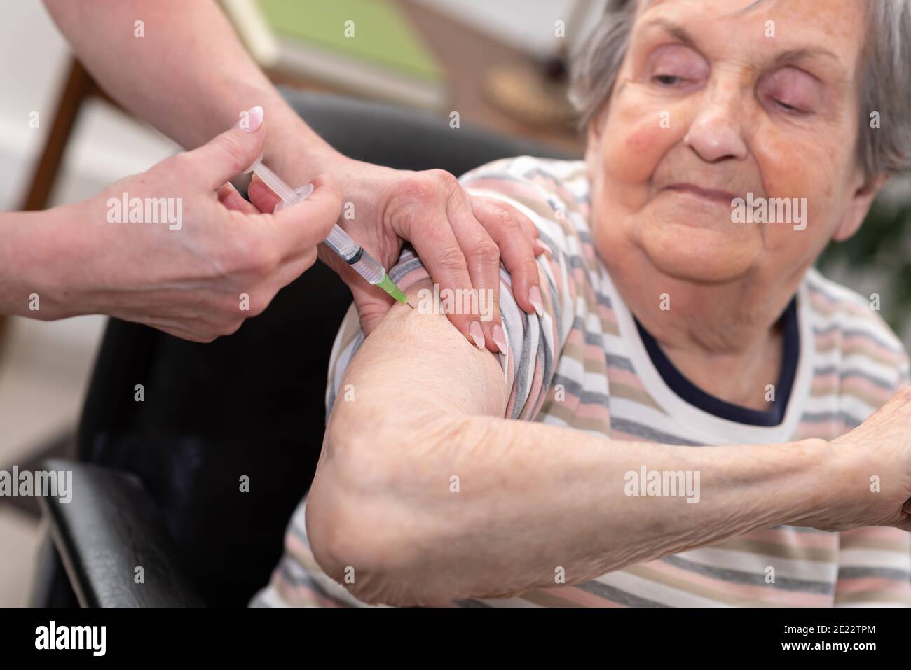 Nurse giving an injection to senior woman Stock Photo - Alamy