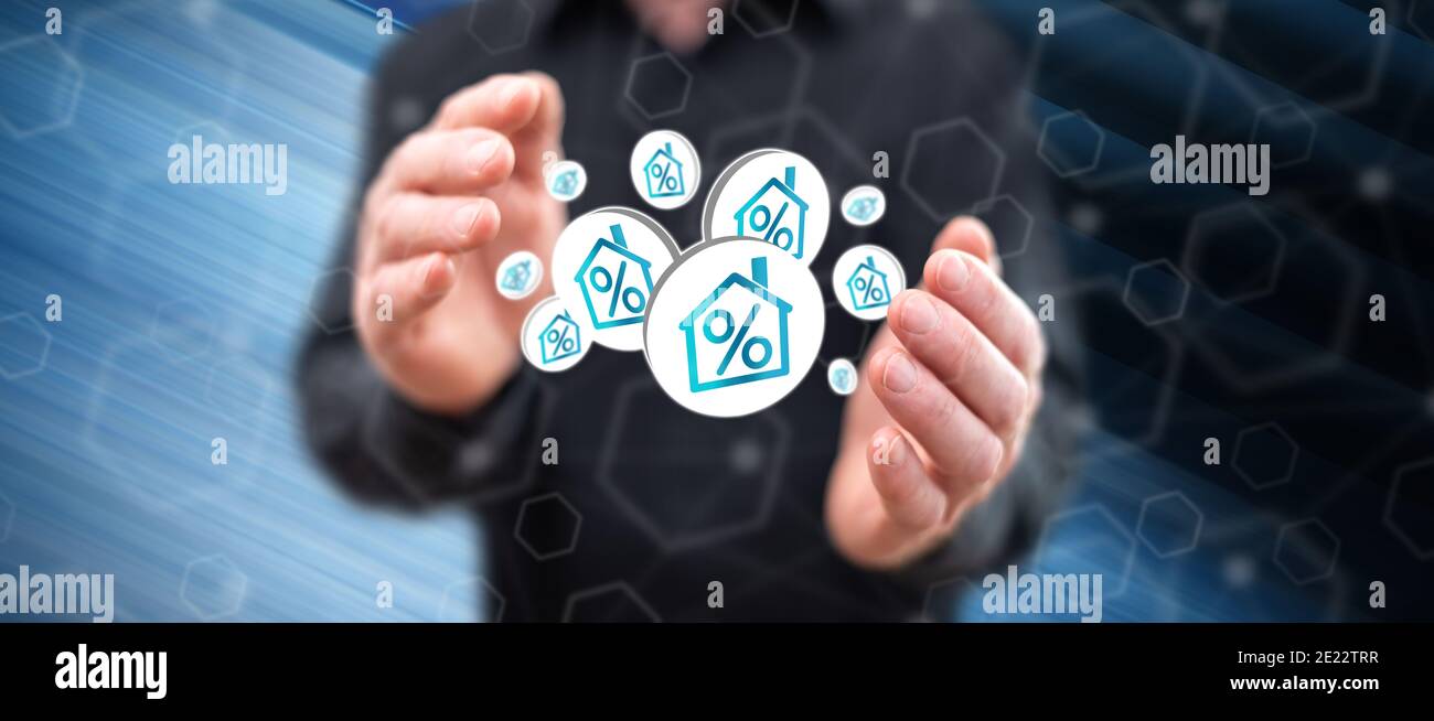 Interest rates concept between hands of a man in background Stock Photo ...