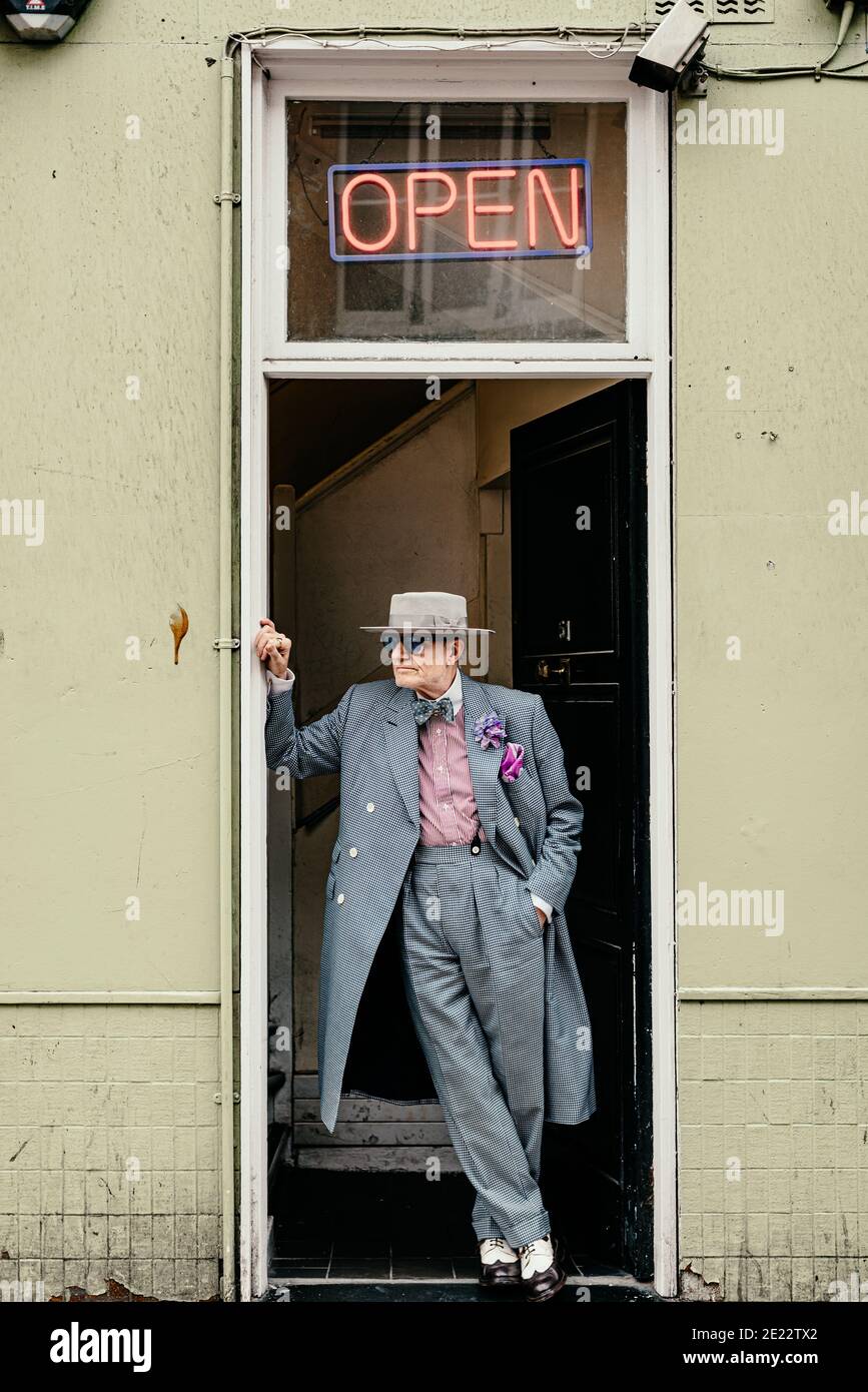 Artist George Skeggs ('Soho George') stands in a doorway on Dean Street ...
