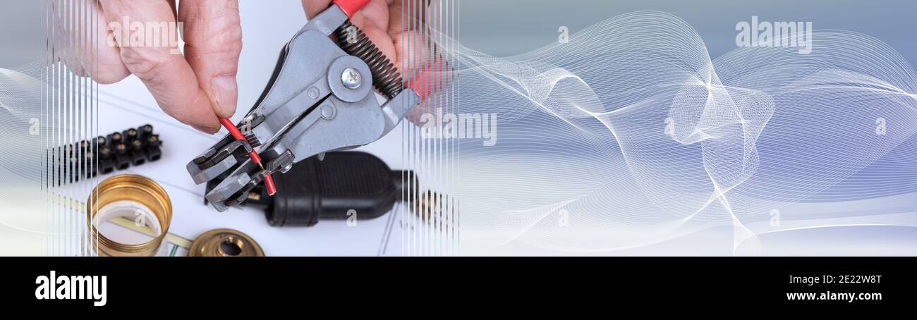 Action to strip a wire with a wire stripper, closeup. panoramic banner ...