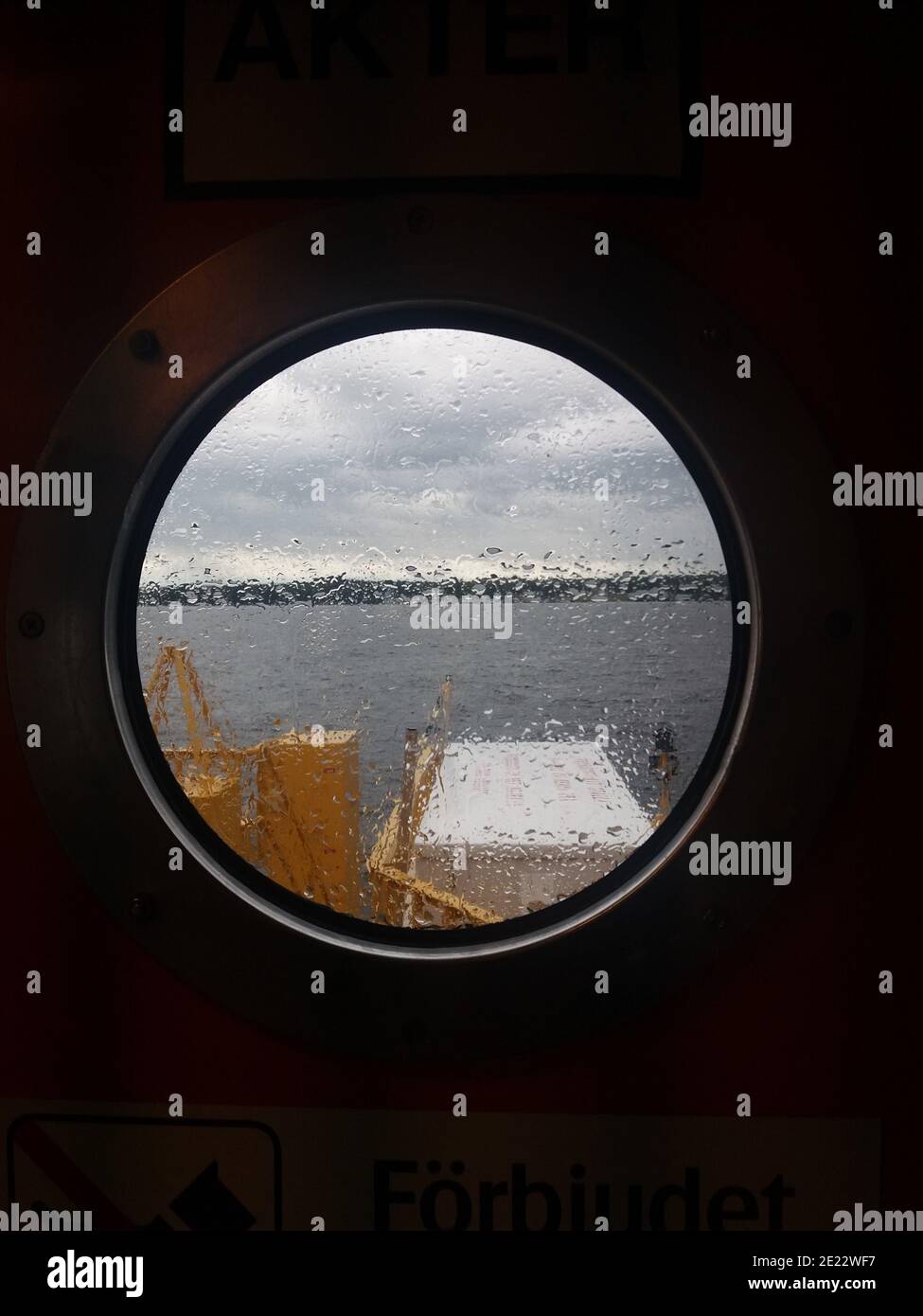 Vertical shot of a round ship window with droplets of rain Stock Photo ...
