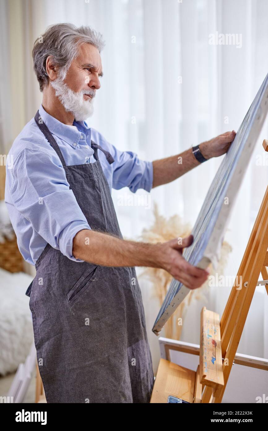 artist man looking at canvas his masterpiece, stand thinking, in ...