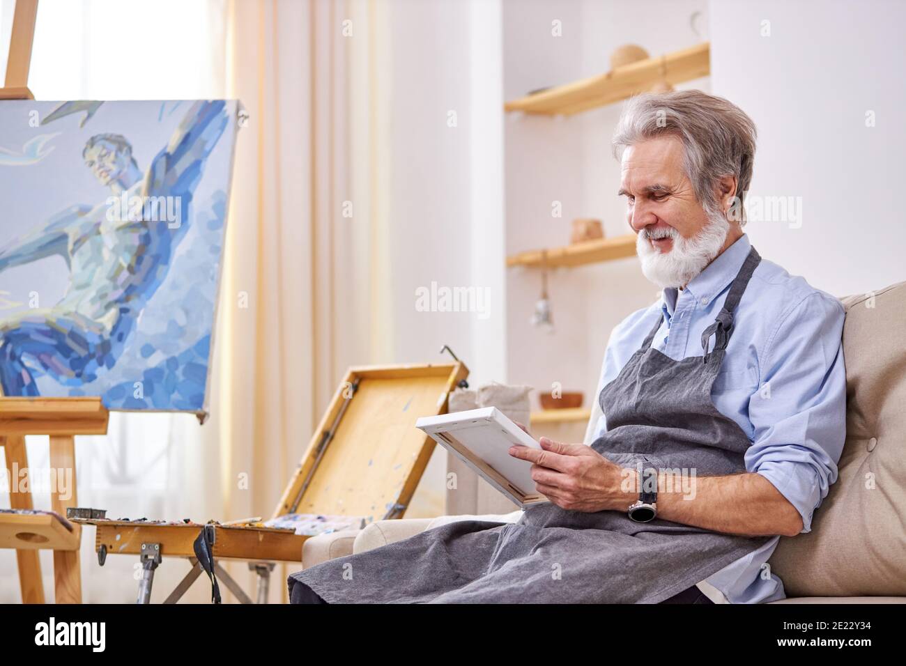 artist sit drawing, smiling, enjoying the work of creating masterpiece. in studio Stock Photo ...