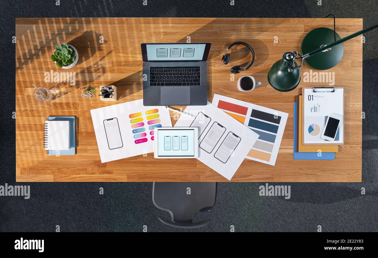 Top view of desk with computer, tablet and paperwork in home office ...