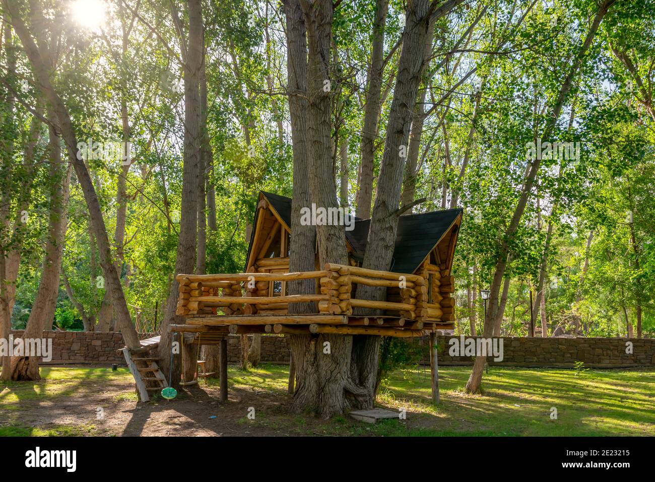 Wooden tree house for children in a park Stock Photo - Alamy