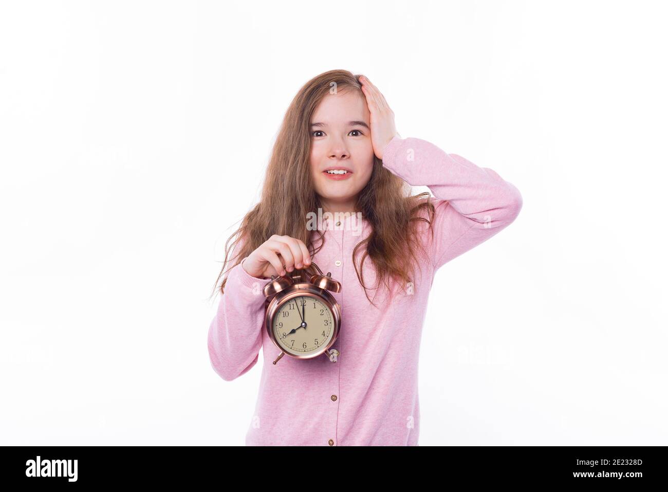 I am late, school girl holding alarm clock and gesturing Stock Photo ...