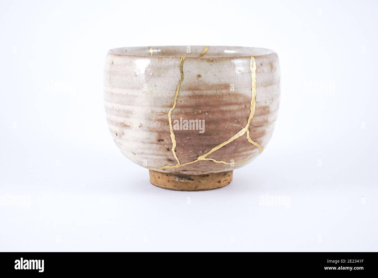 Japanese Kintsugi beige tea cup, gold cracks on antique pottery Stock ...