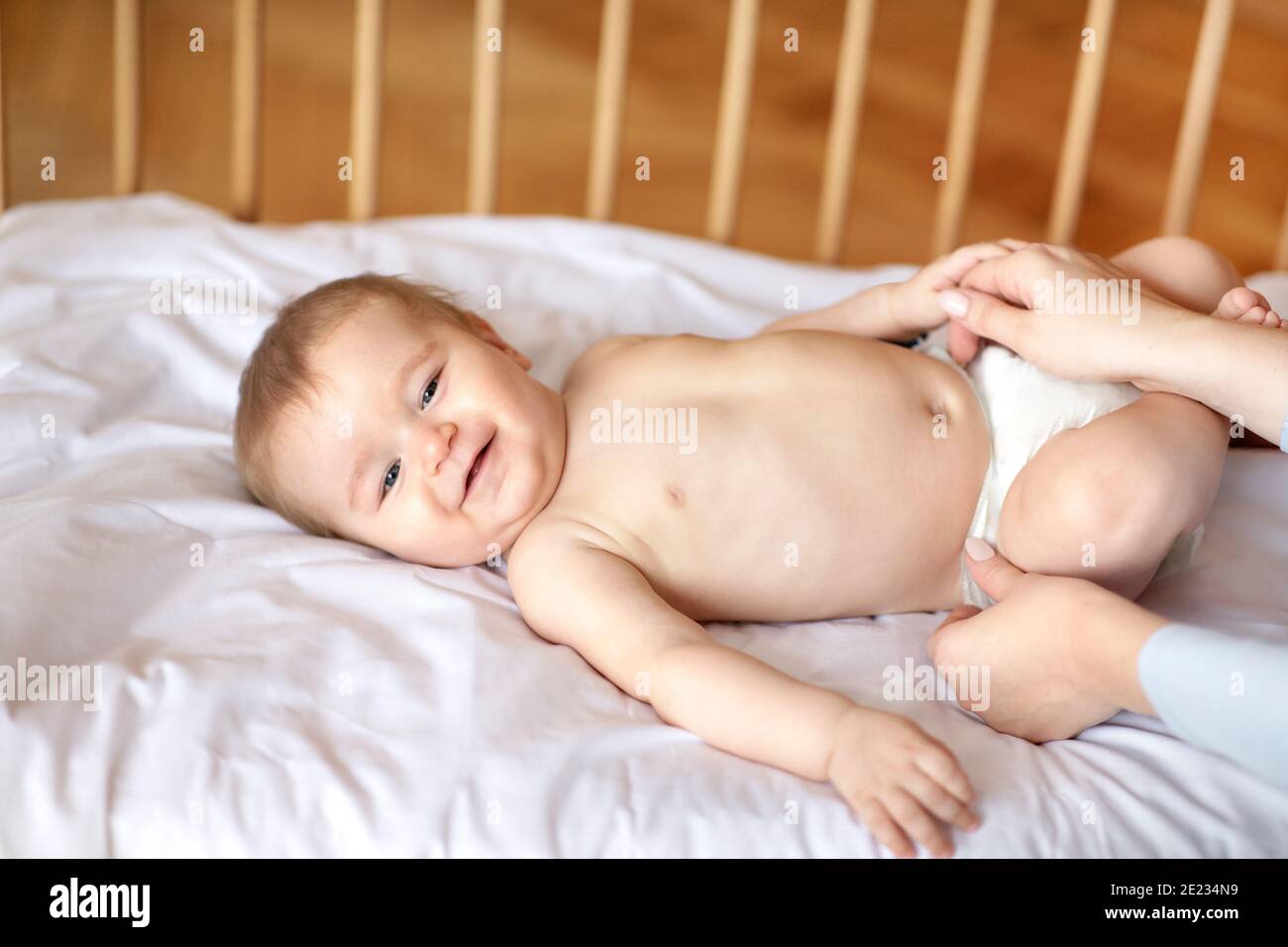 Adorable baby having fun while mom changing diaper Stock Photo - Alamy