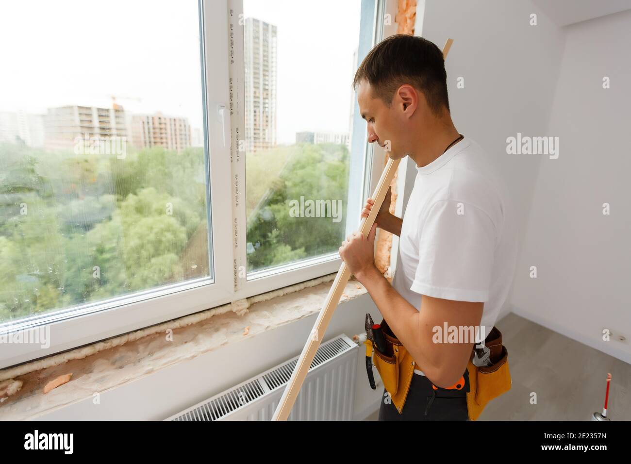 male industrial builder worker at window installation in building ...